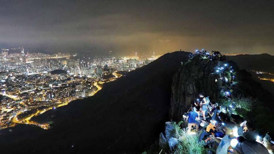 More than 1,000 people gathered on top of Hong Kong's Lion Rock to ...